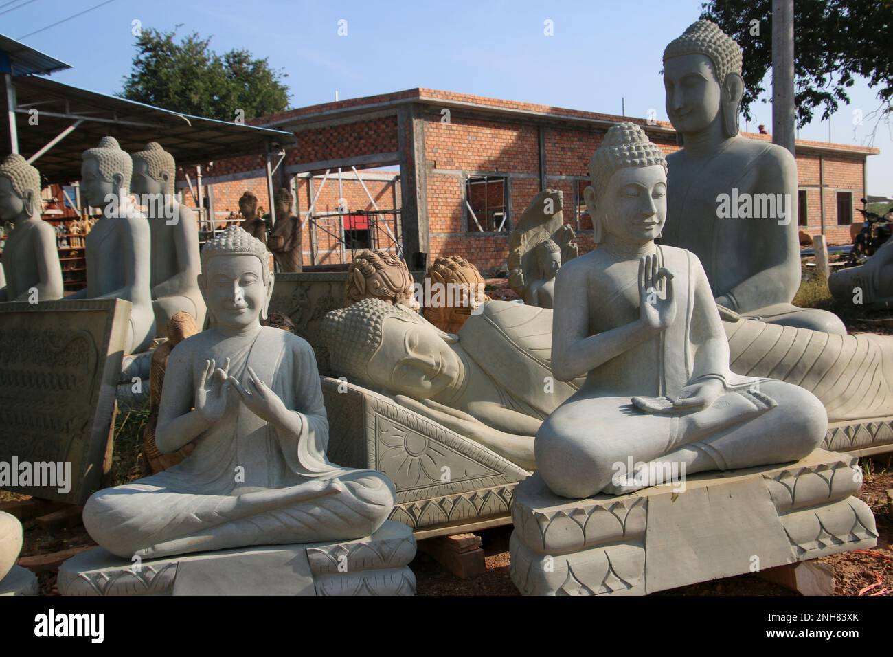 Local stonemason at work, fashioning buddha statues, Photographed in ...