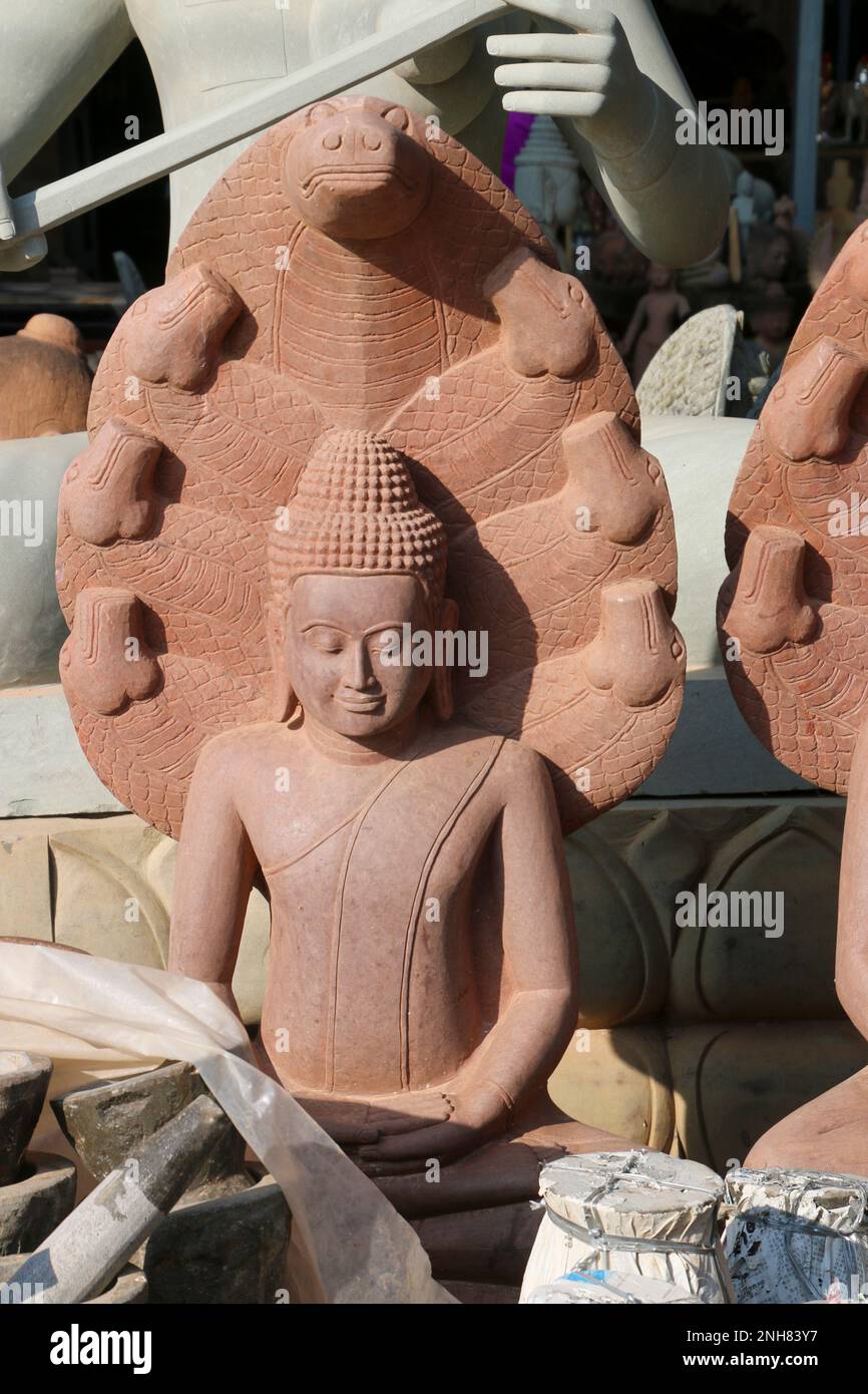 Local stonemason at work, fashioning buddha statues, Photographed in ...