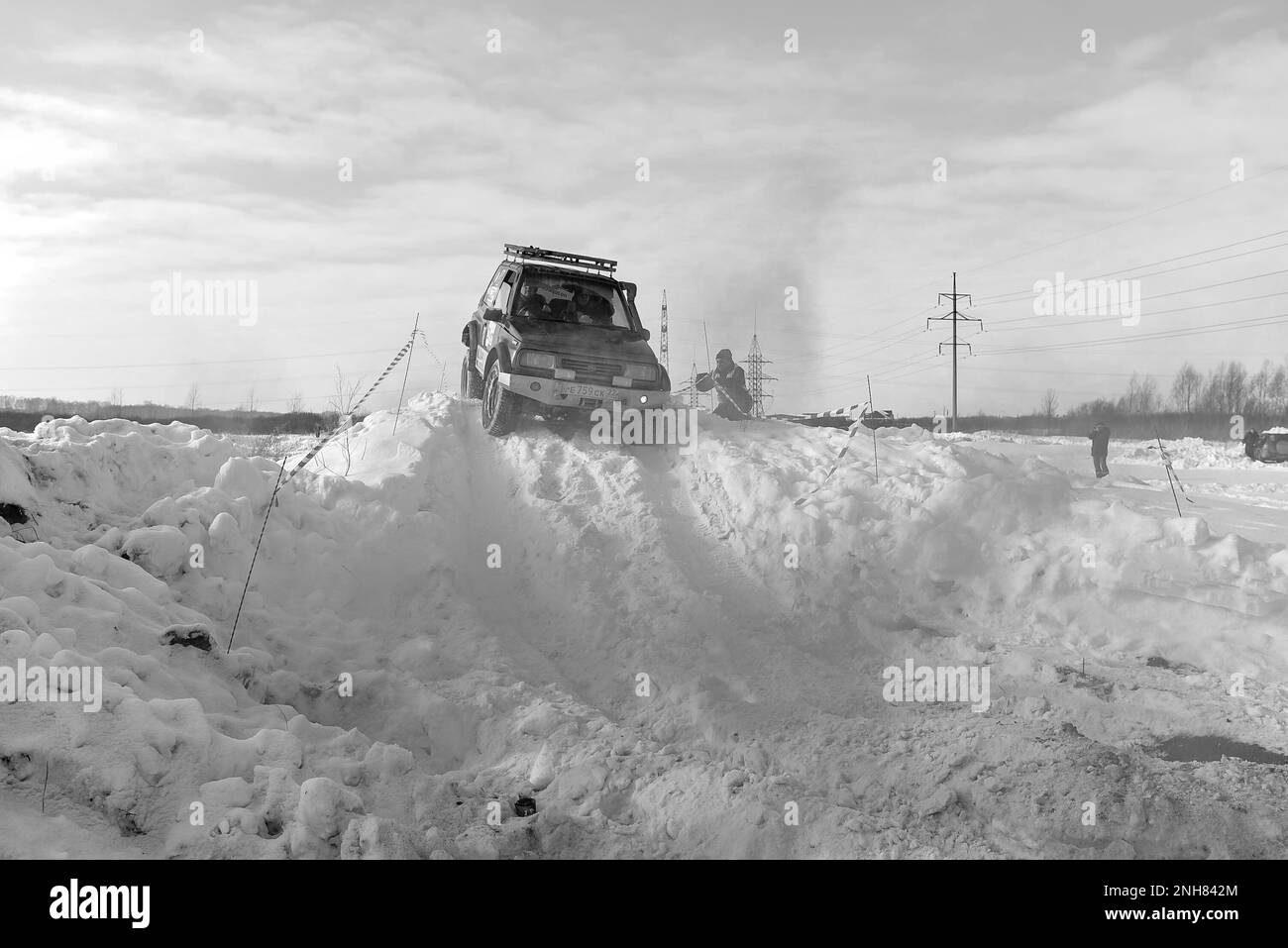 Offroad SUV "Suzuki Escudo" 4x4 quickly goes on a snowy road in the ...