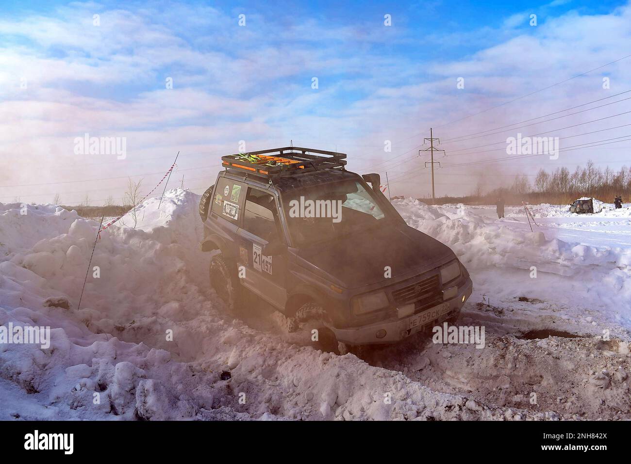 Offroad SUV "Suzuki Escudo" 4x4 quickly goes on a snowy road in the ...
