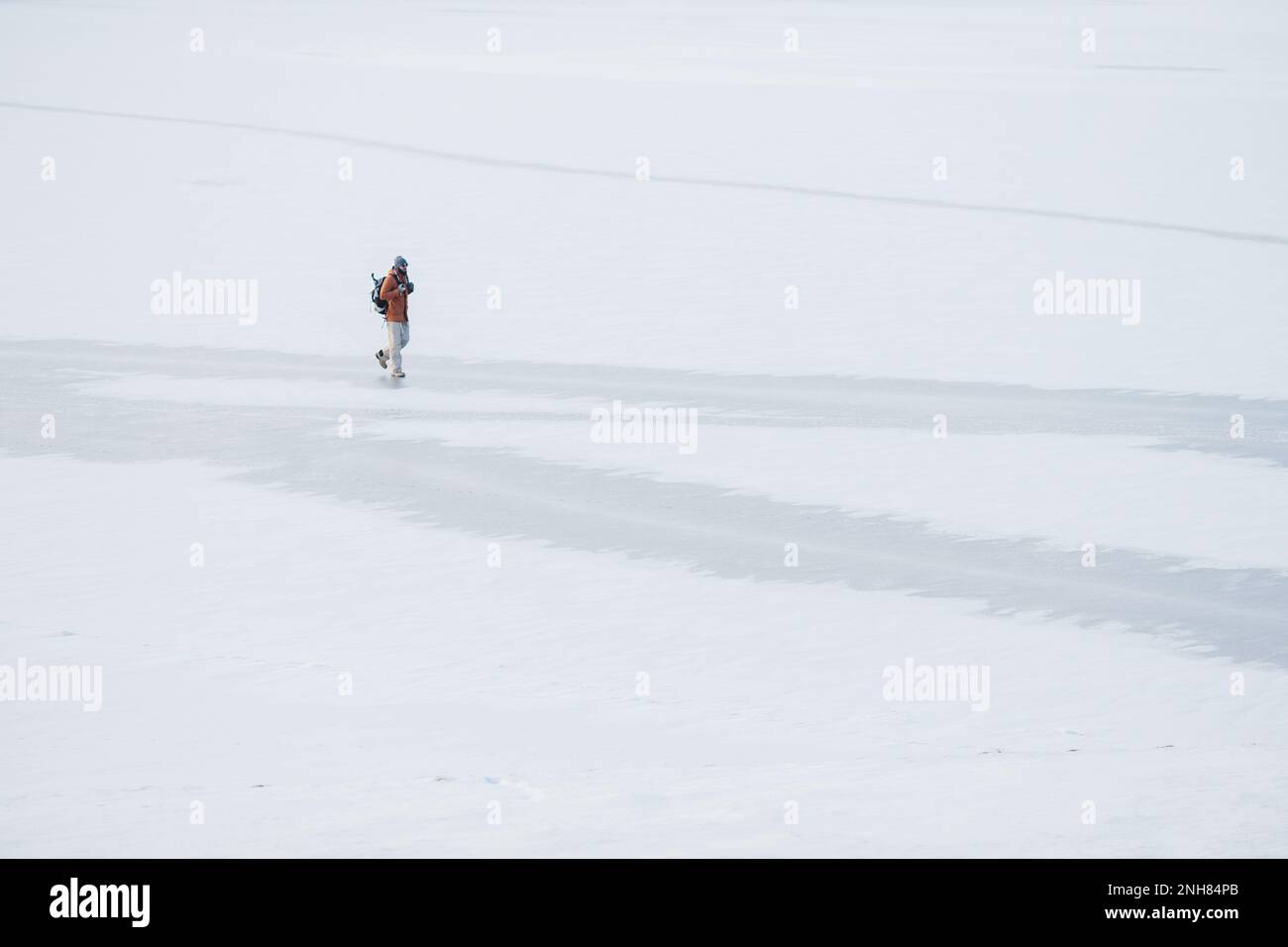 Tourist in snowy mountains. Winter landscape with a climber on the ...