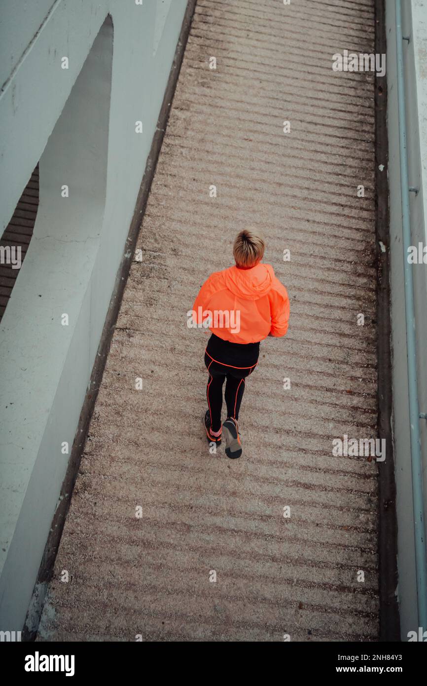 Top view photo of omen in sports clothes running in a modern urban ...