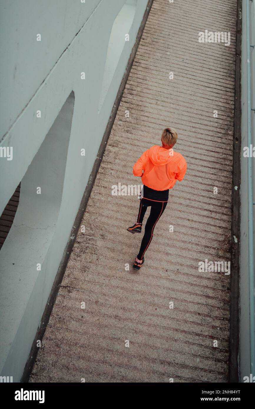 Top view photo of omen in sports clothes running in a modern urban ...