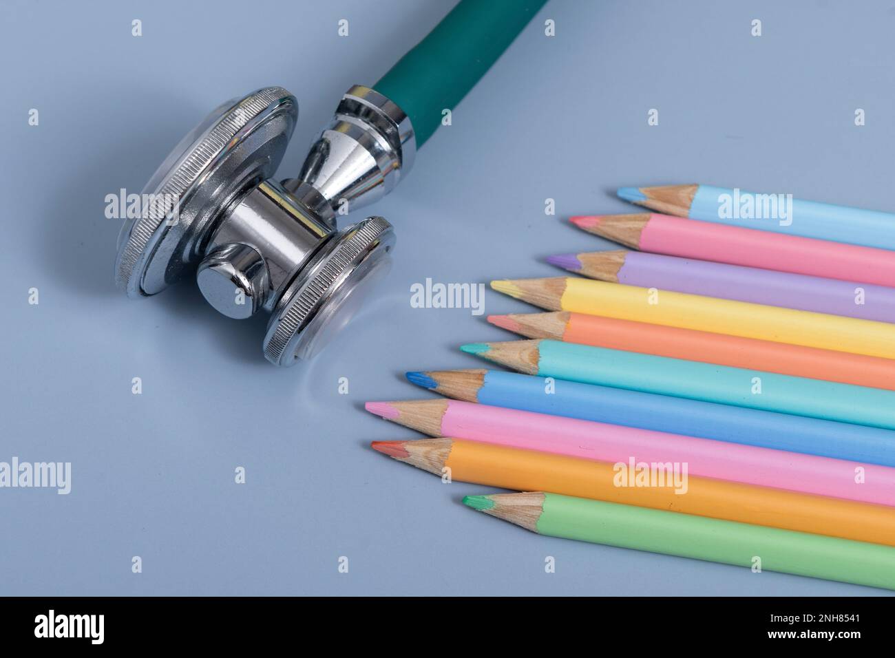 palette of colored pencils and a stethoscope representing the ...