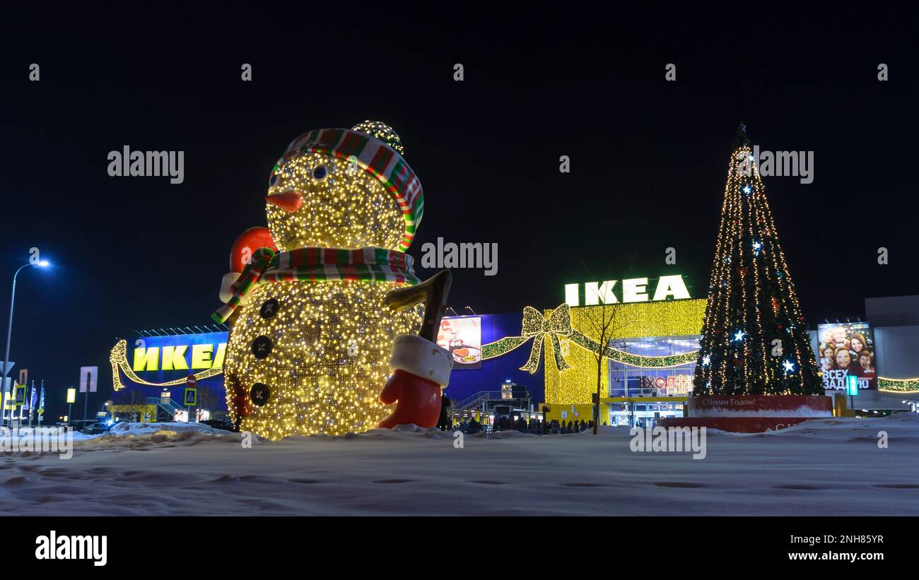 Christmas decorations at the store "IKEA" in the winter. Large glowing ...