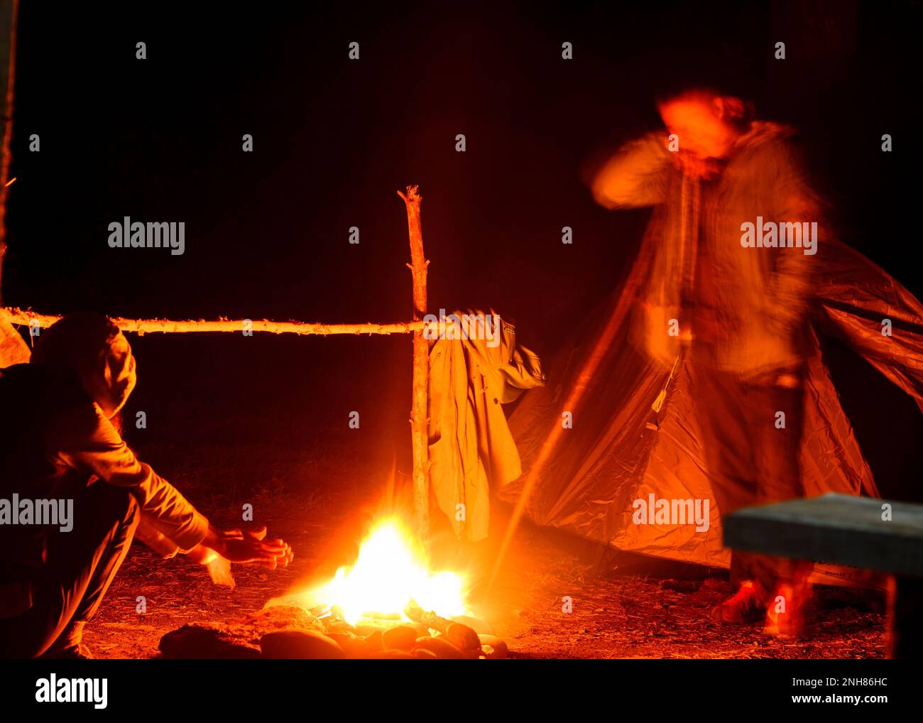 Abstract photo of silhouettes of people around a night fire Stock Photo ...