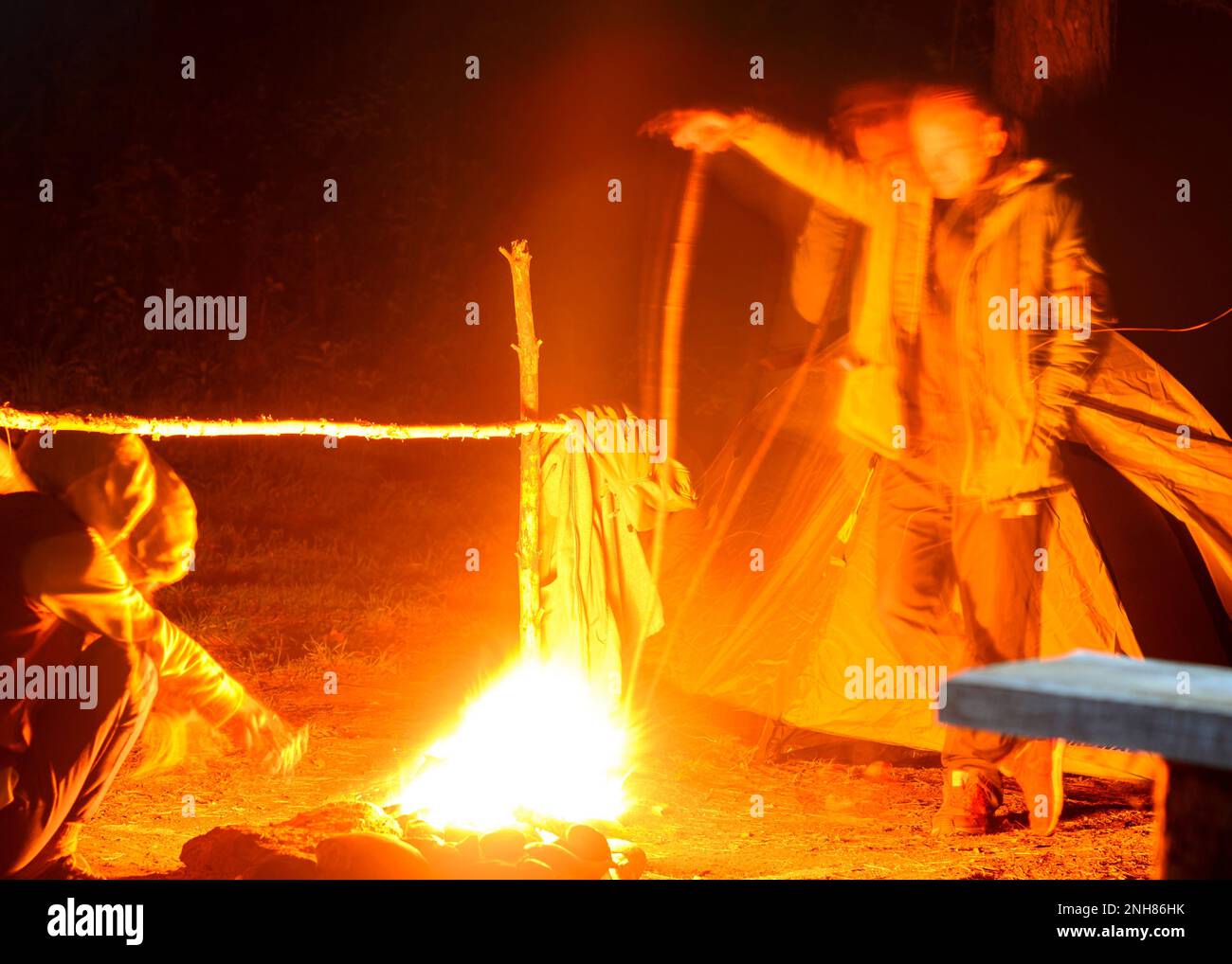 Abstract photo of silhouettes of people around a night fire Stock Photo ...