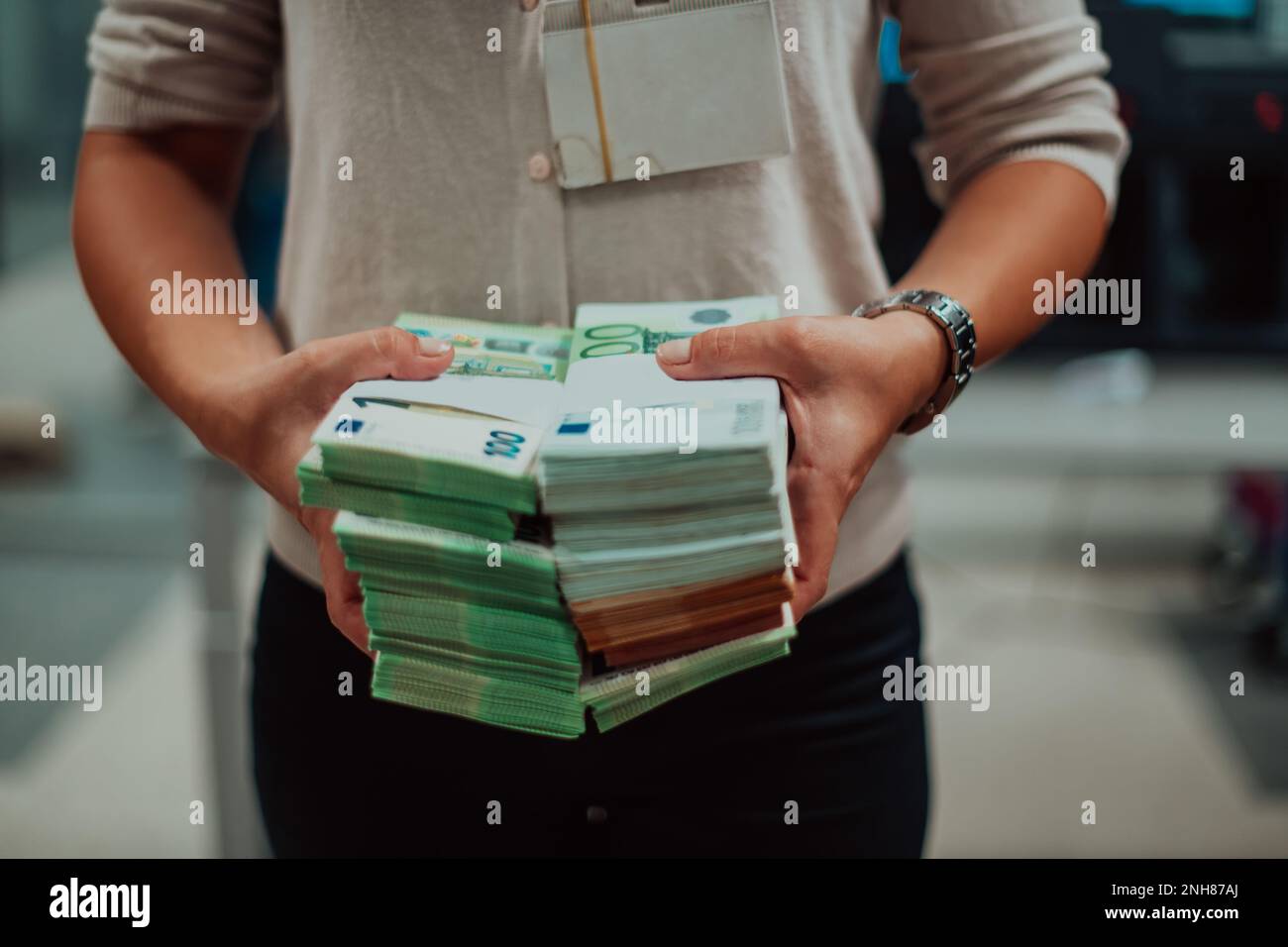 Bank employees using money counting machine while sorting and counting ...