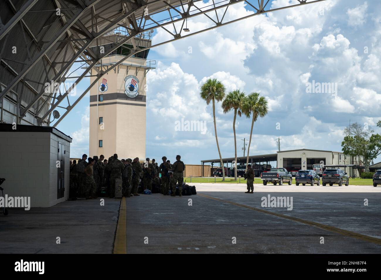 U.S. Air Force Airmen assigned to the 23rd Wing sit under a hangar ...