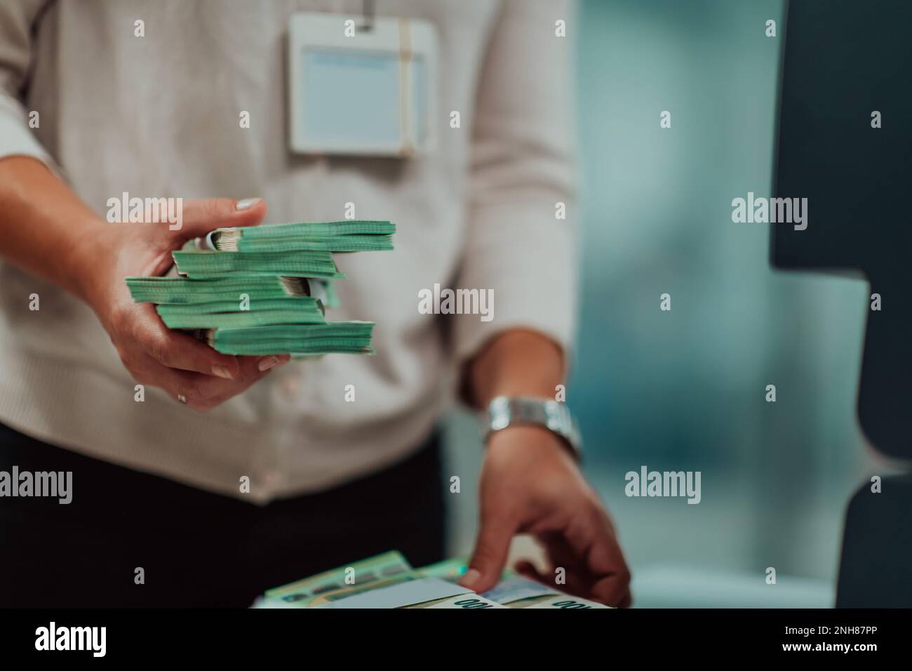 Bank employees using money counting machine while sorting and counting ...