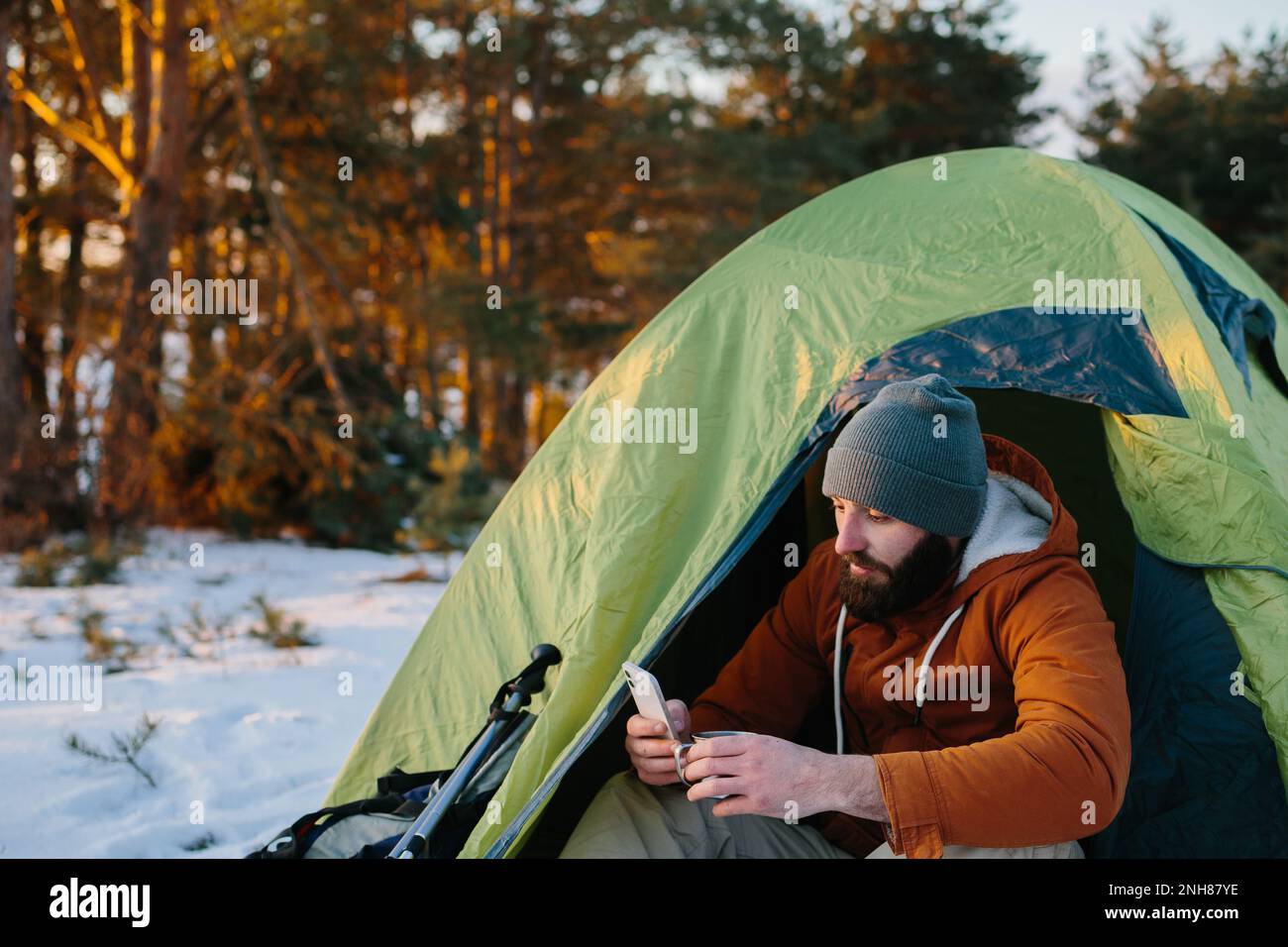 A tired tourist rests after a difficult climb sitting in a tent in a ...