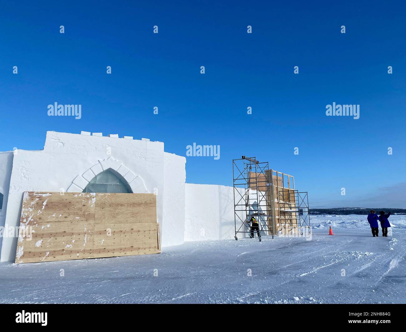 Workers construct the snow castle on Great Slave Lake's Yellowknife Bay ...
