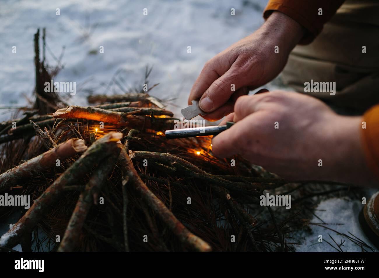 Male hand starts fire with magnesium fire steel, fire striker Stock ...