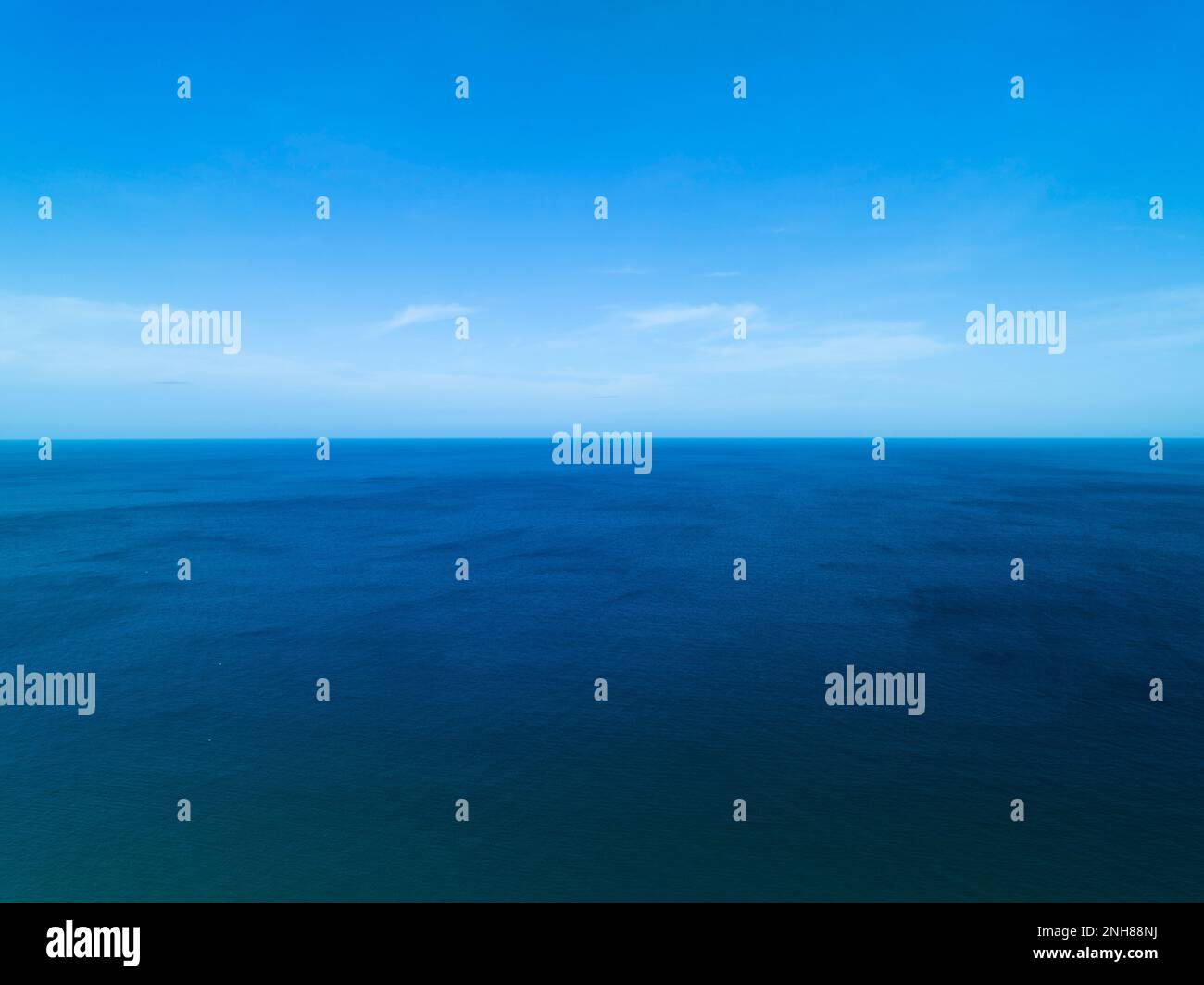 Aerial view of a blue sea surface water texture background and sun ...