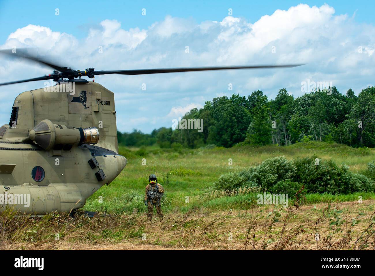A CH-47 Chinook crew member waits to board simulated patients for ...