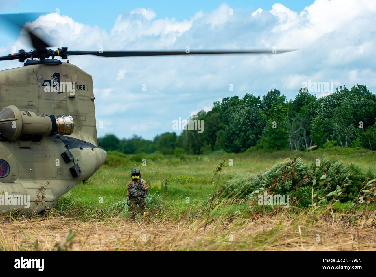 A CH-47 Chinook crew member waits to board simulated patients for ...