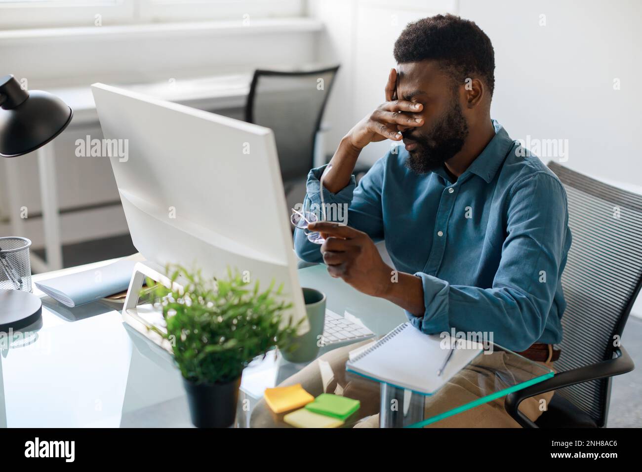 Tired black businessman feeling pain eyestrain, holding glasses and ...