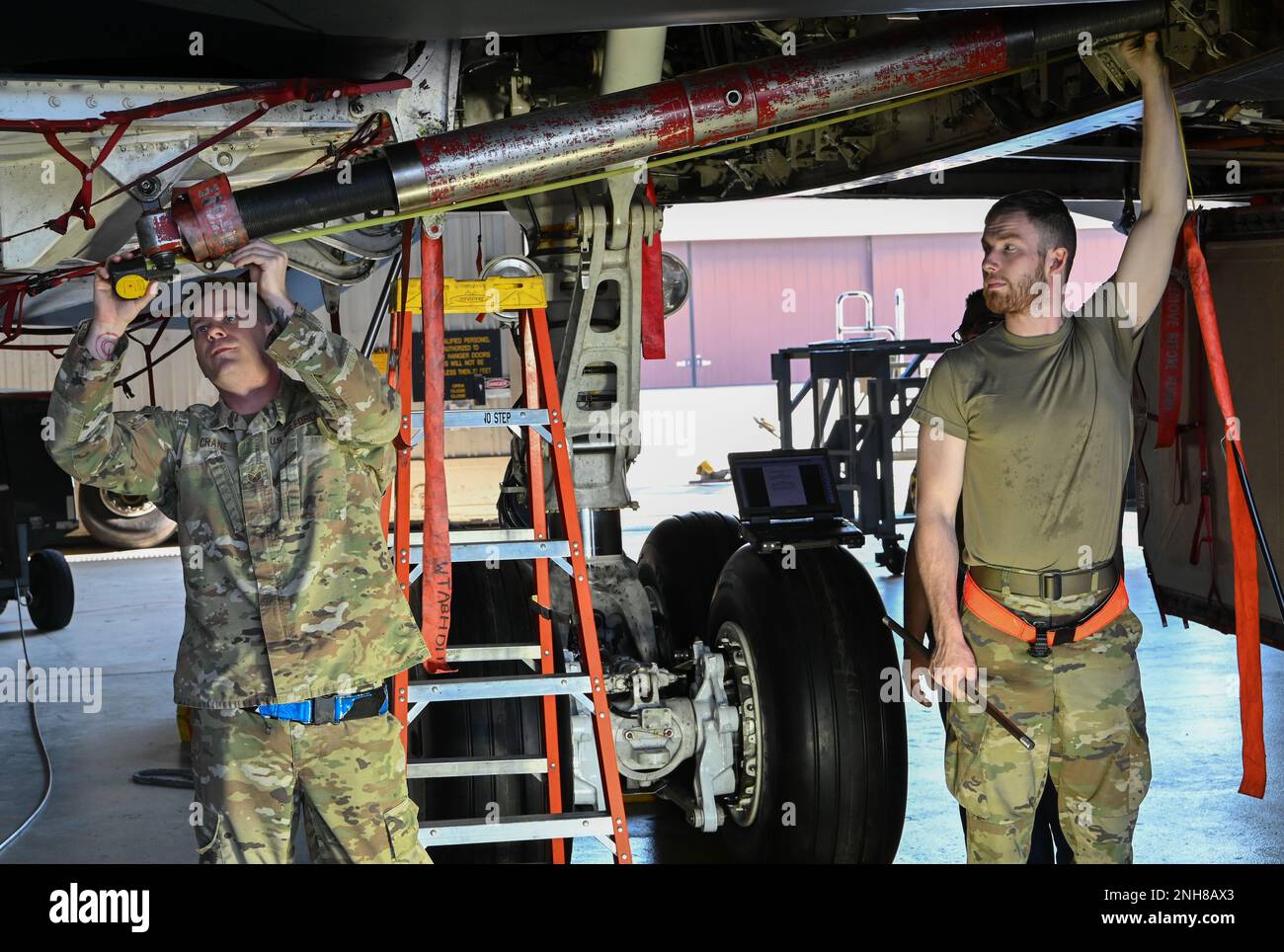 Staff Sgt. Robert Crane and A1C Elijah Austin measure a component on ...