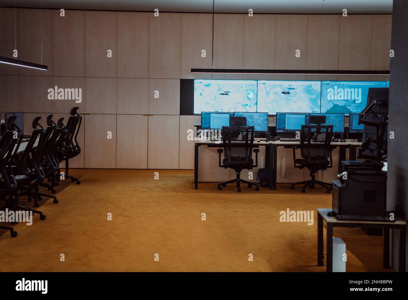 Empty interior of big modern security system control room, workstation ...