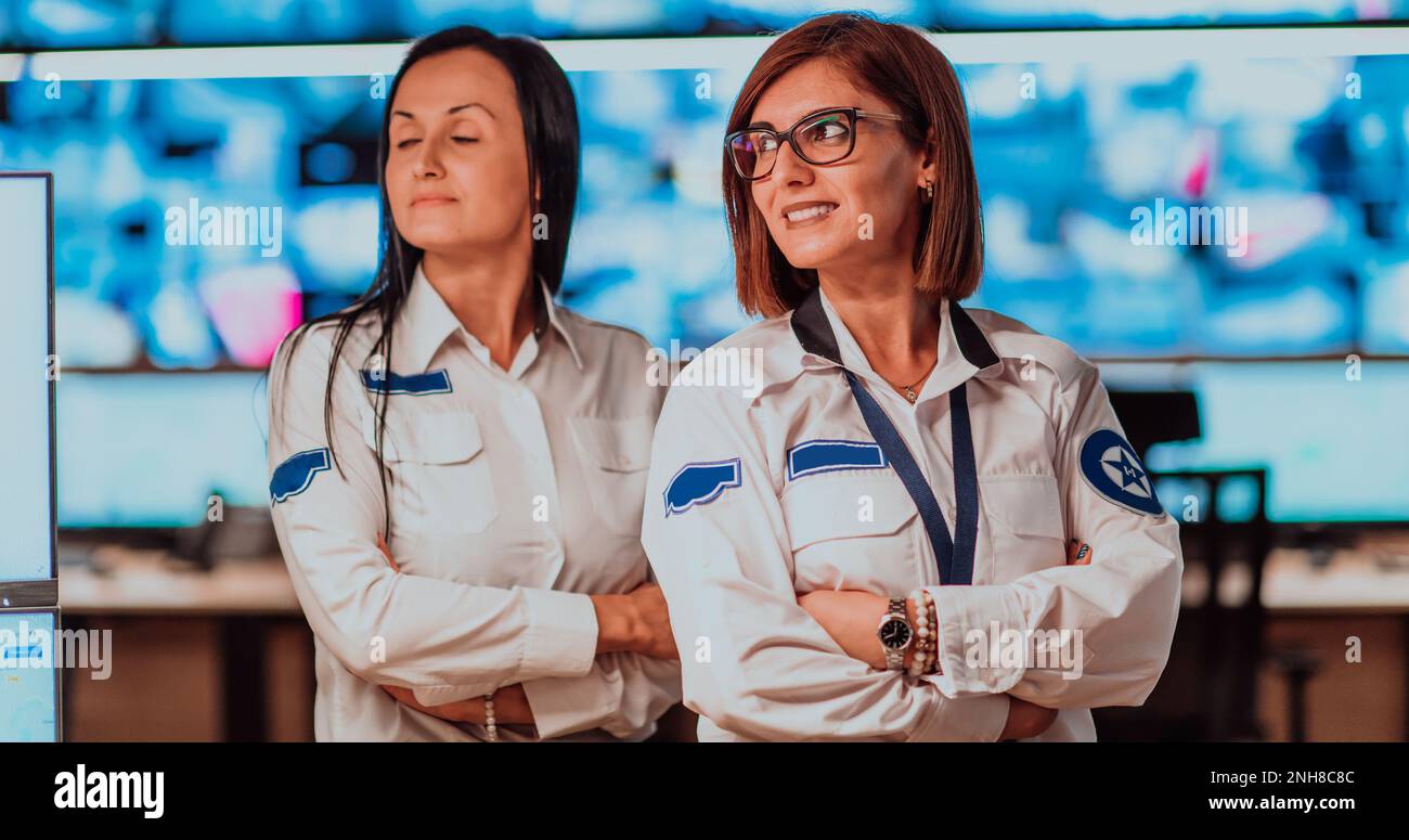 Group portrait of female security operator while working in a data ...