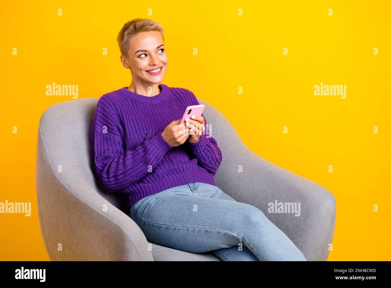 Portrait of minded pretty lady sit chair hold telephone look empty ...