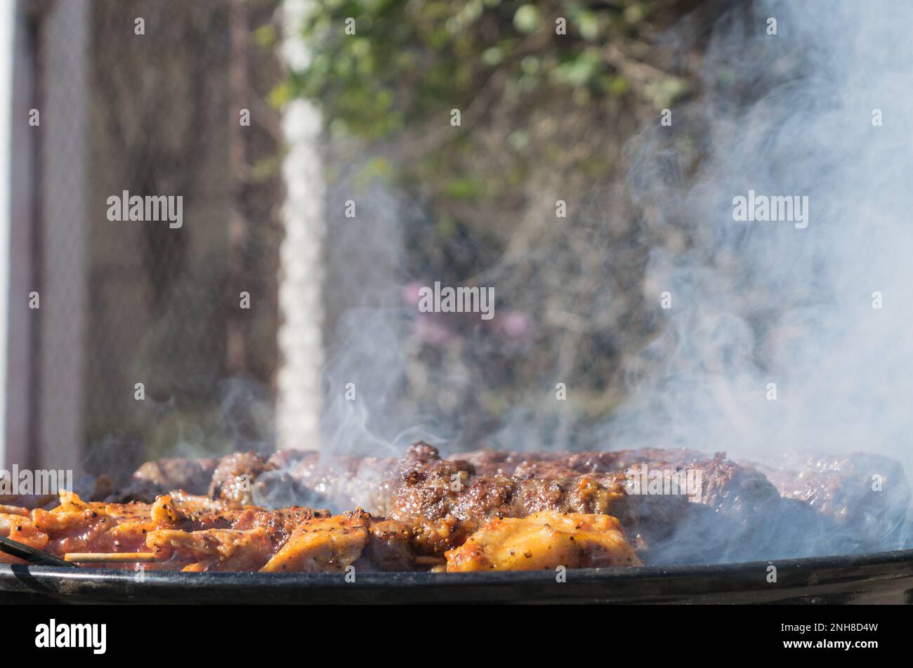 barbeque grill with smoke in backyard Stock Photo - Alamy