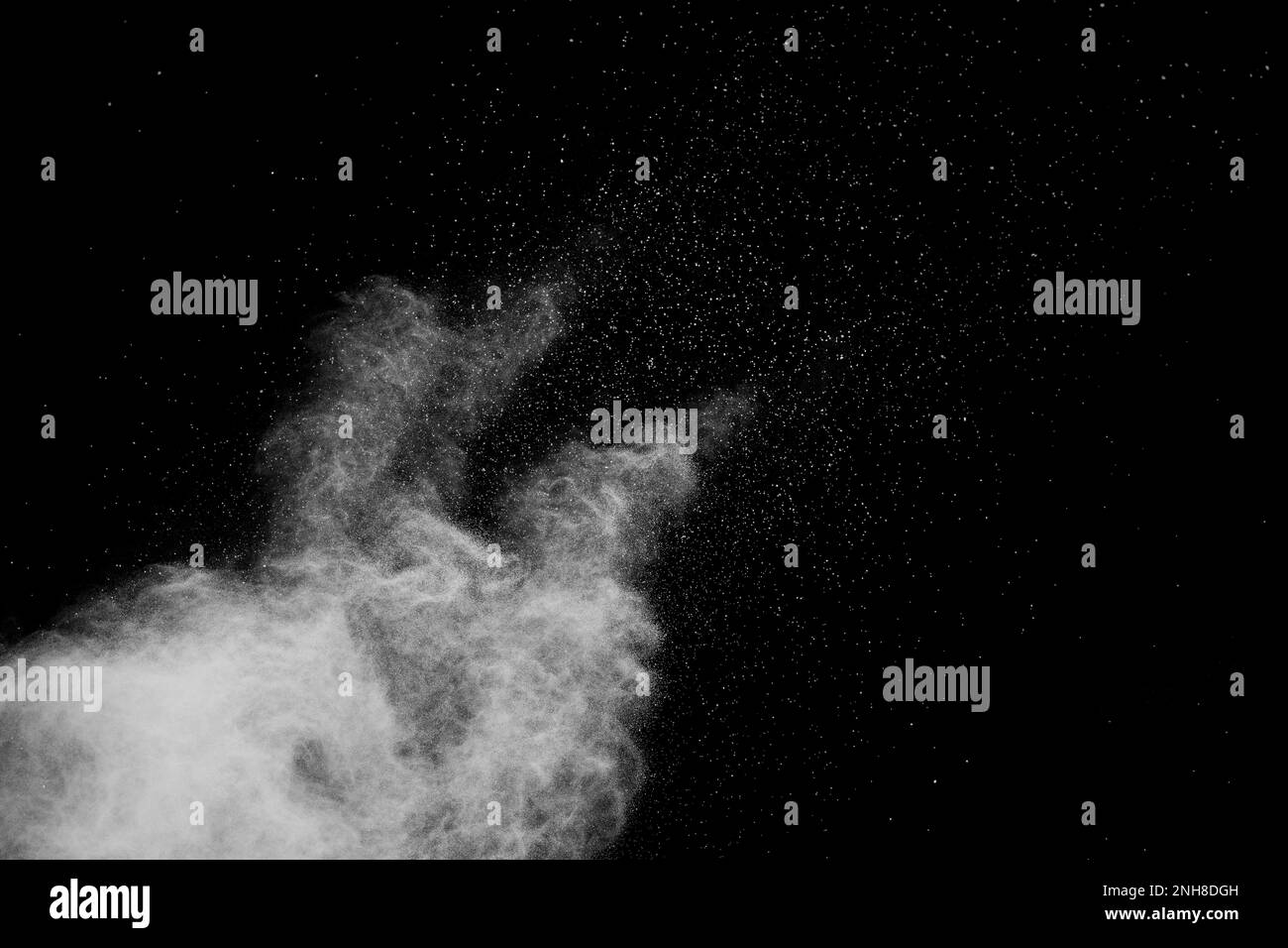 White powder explosion isolated on black background.White dust ...