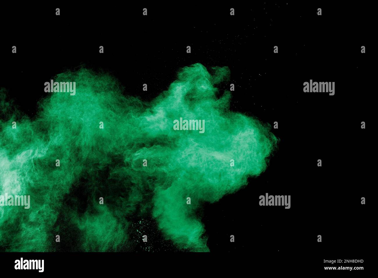 Green color powder explosion cloud on black background.Green dust ...