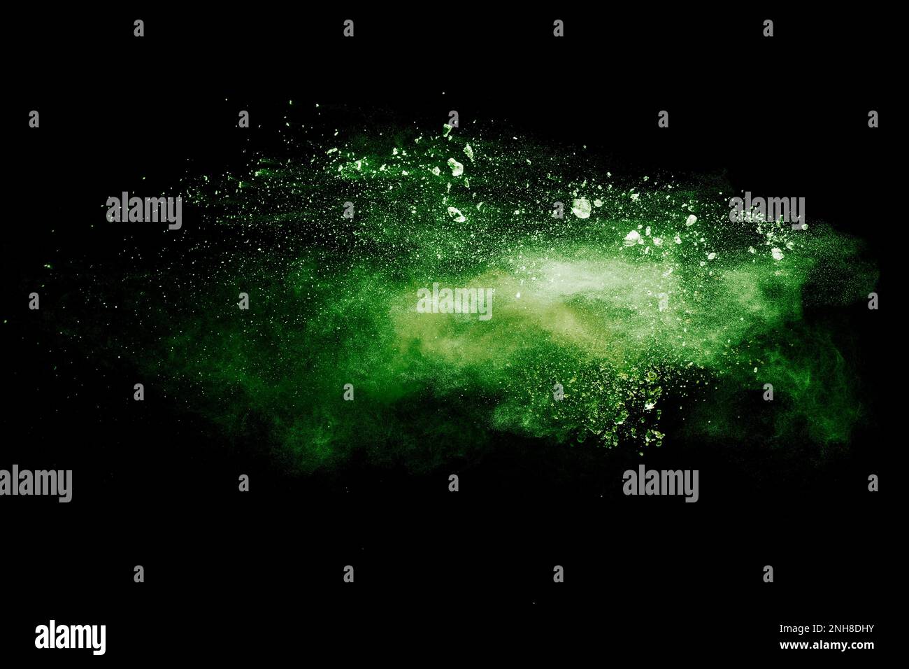 Green color powder explosion cloud on black background.Green dust ...