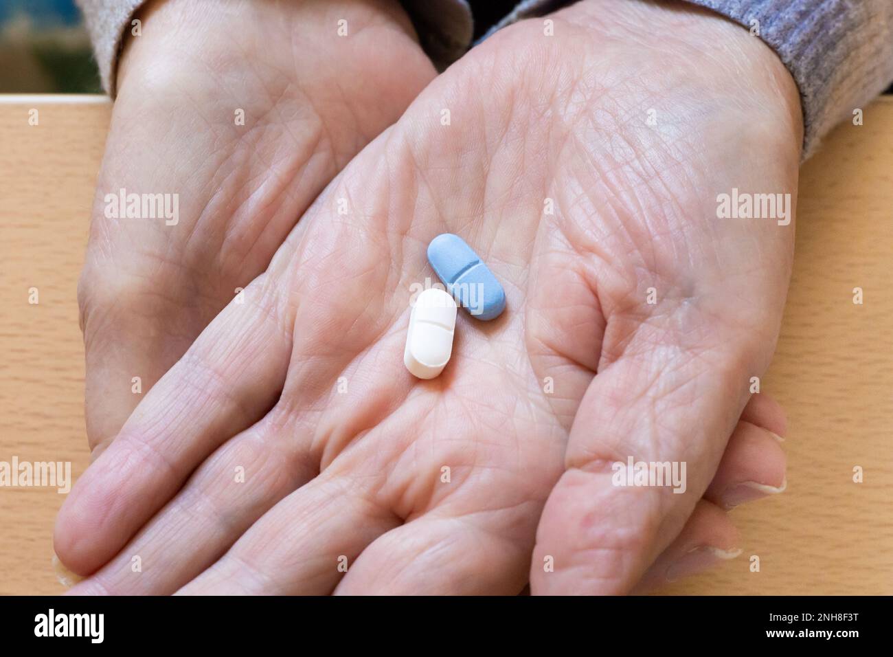 Old person wrinkled hands holding pills. Medical insurance ...