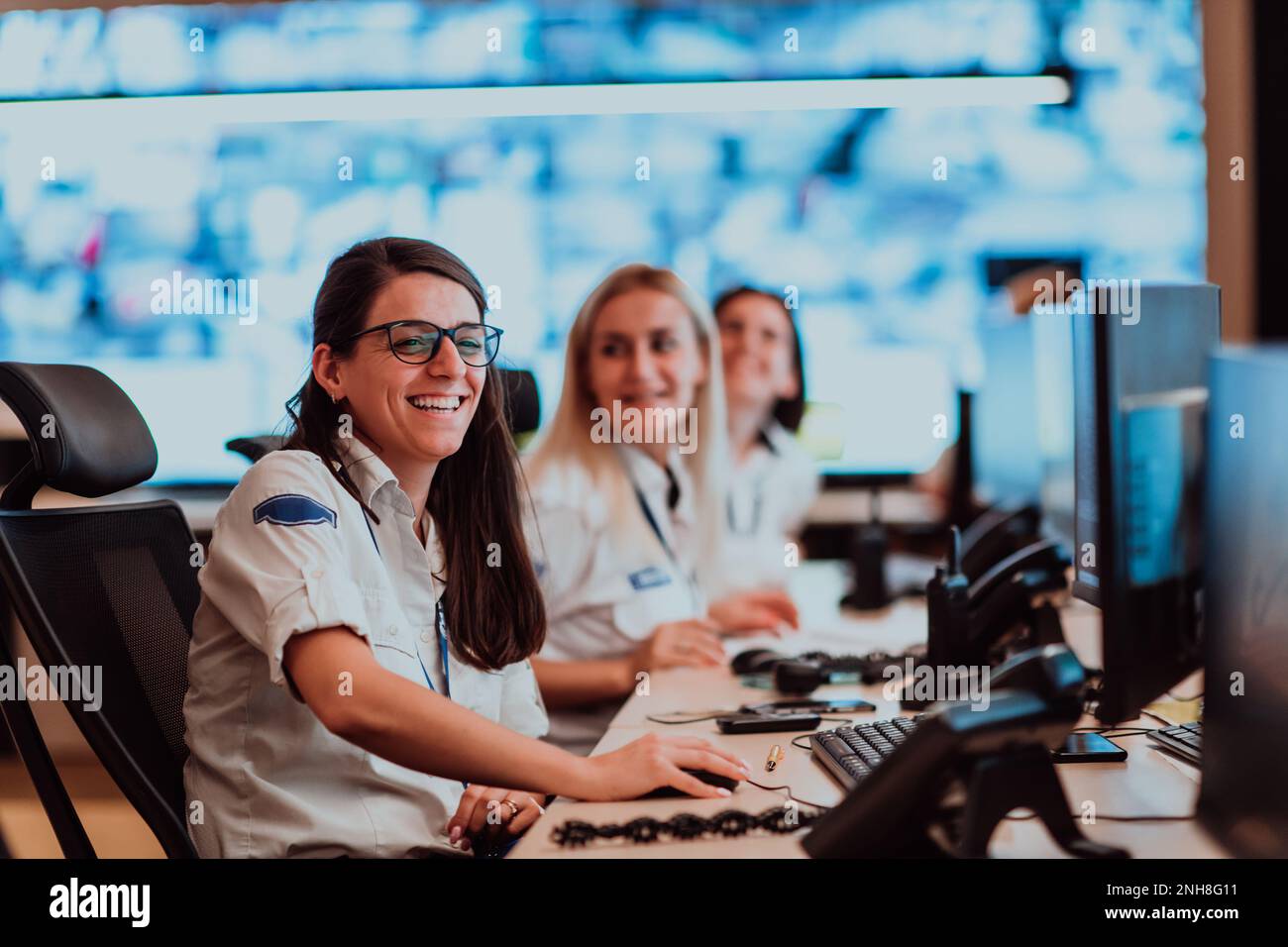 Group of Security data center operators working in a CCTV monitoring ...