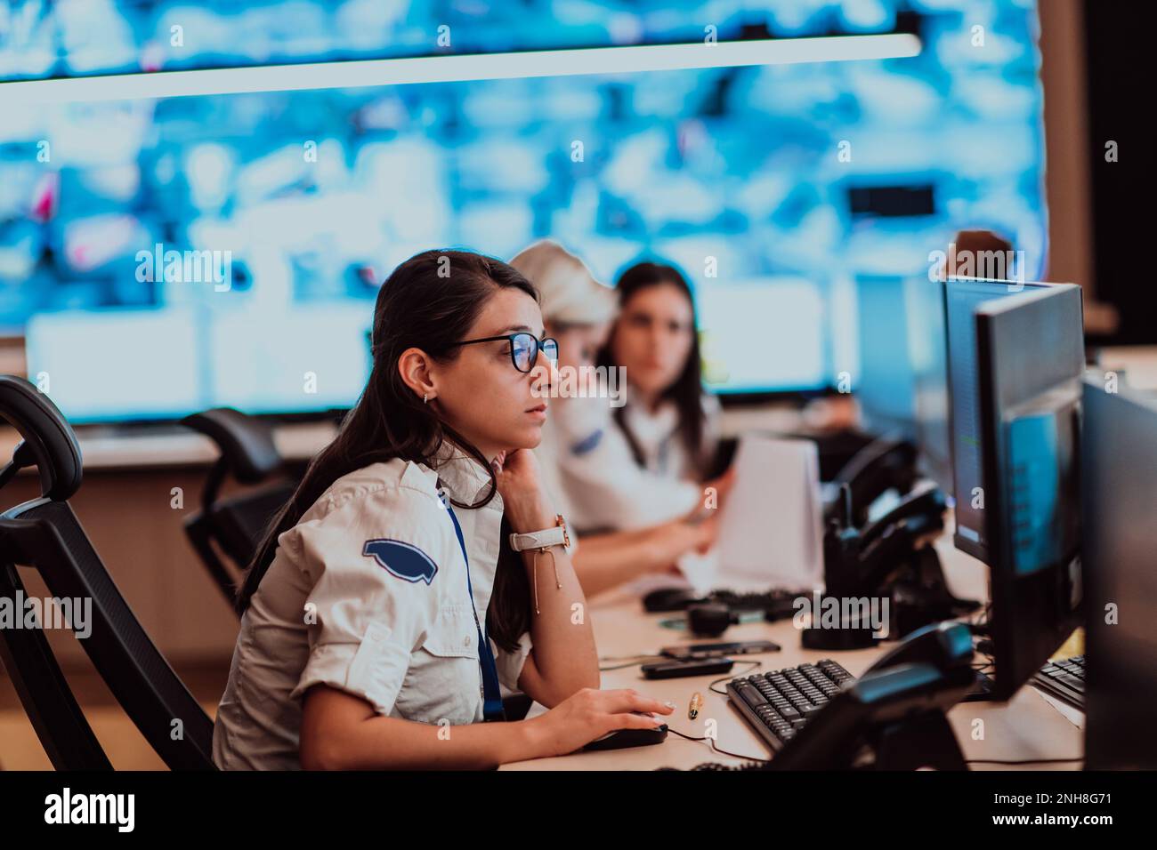 Group of Security data center operators working in a CCTV monitoring ...