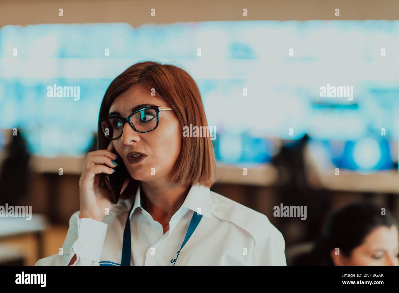 Female security operator working in a data system control room offices ...