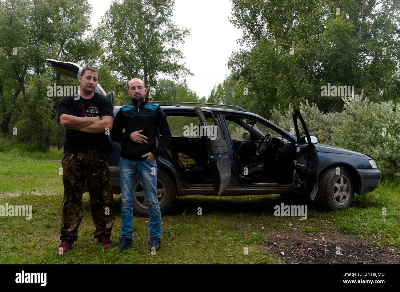 Russian men two friends are standing near an old Toyota car in the ...