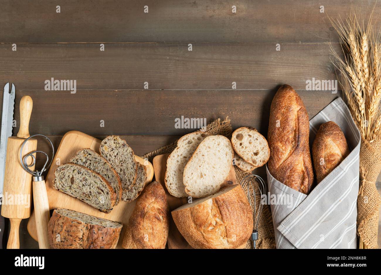 slide multi grain sourdough bread and sliced Baguette on wood ...
