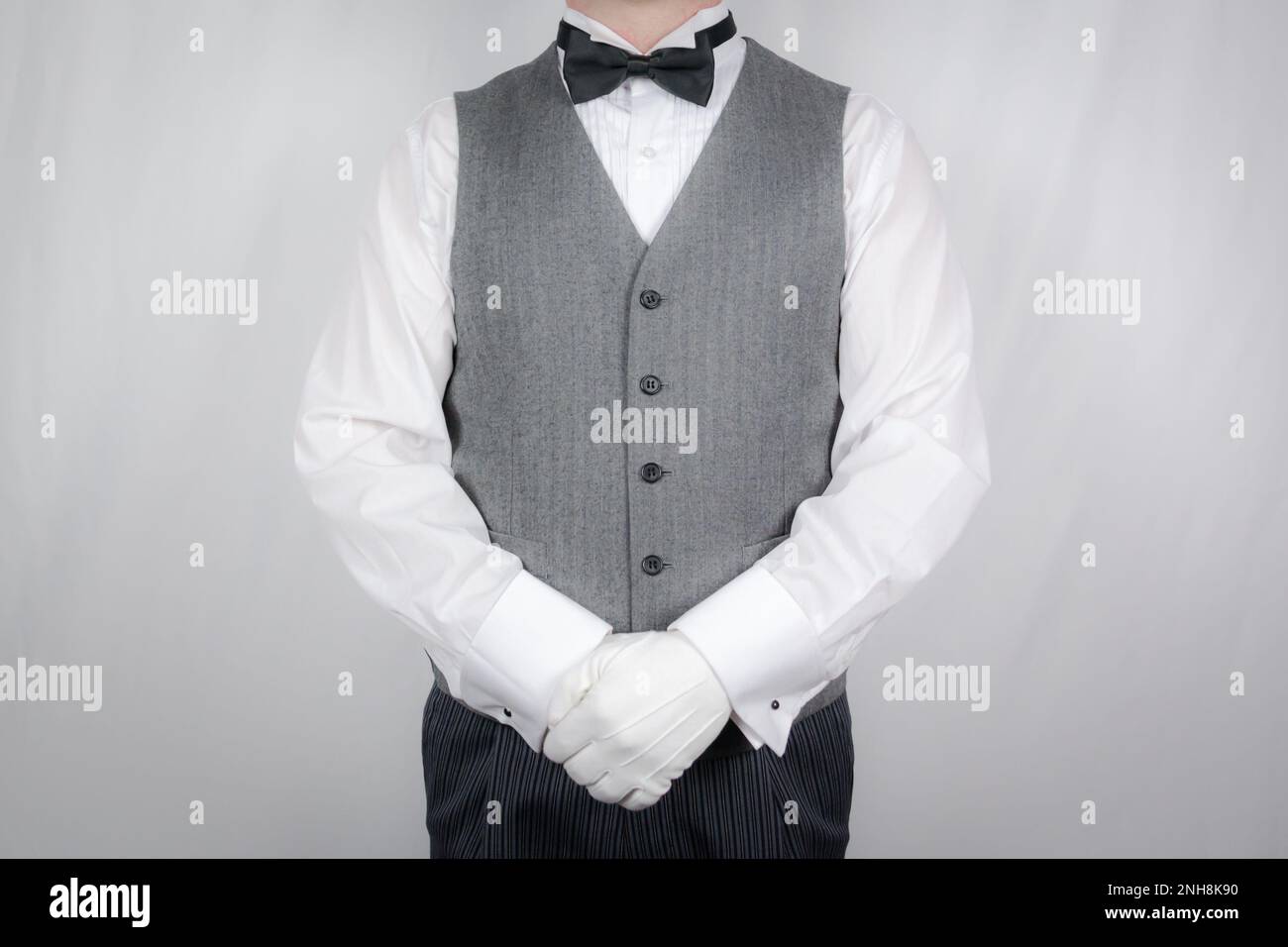 Portrait of Butler or Waiter in Gray Vest and White Gloves Standing and ...