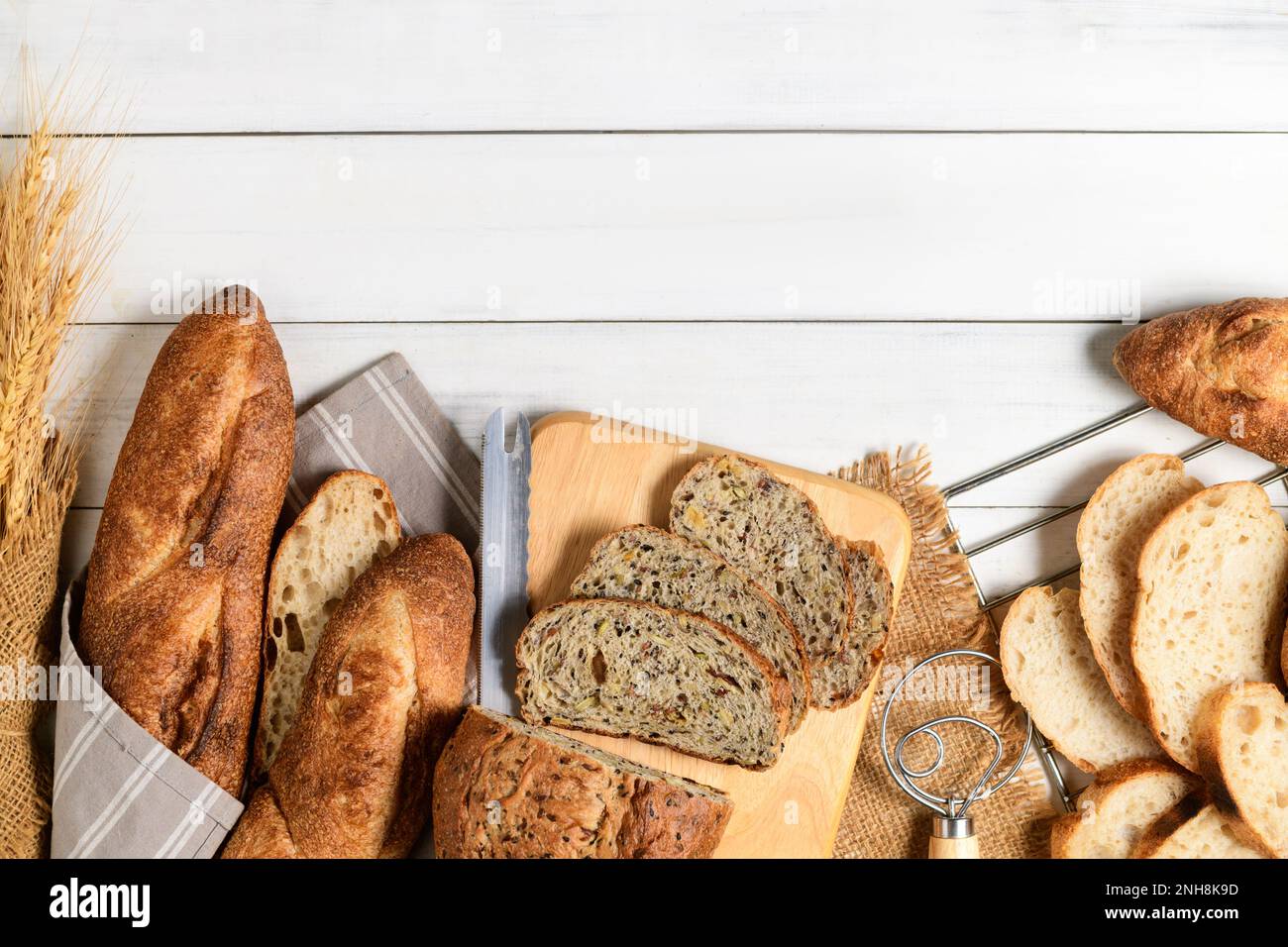 slide multi grain sourdough bread and sliced Baguette on white wood ...