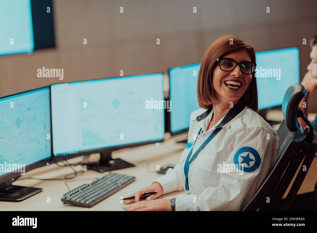 Female security operator working in a data system control room offices ...