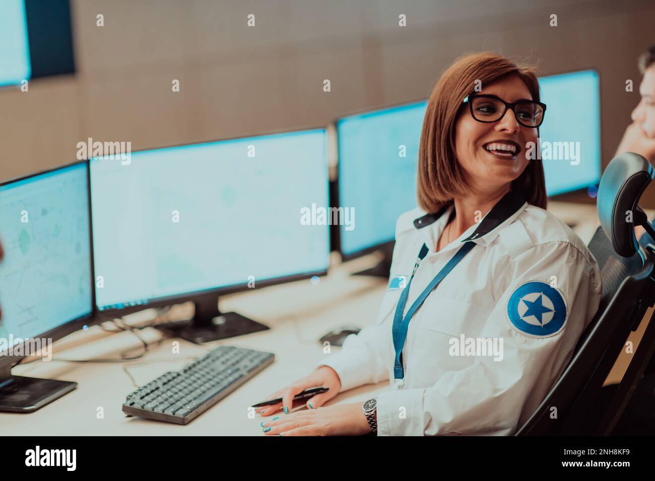 Female security operator working in a data system control room offices ...
