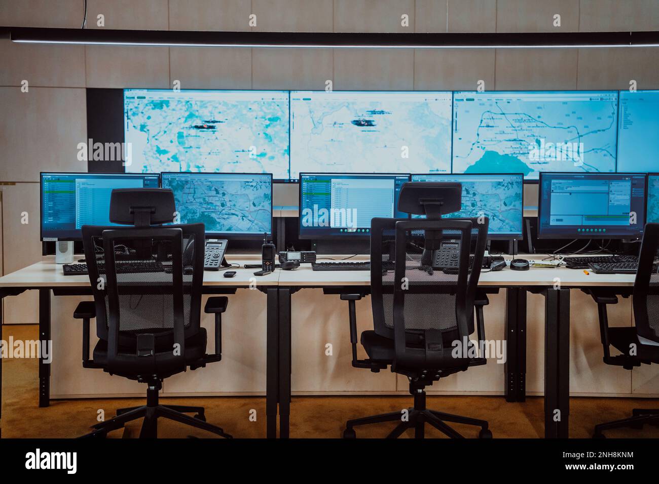 Empty interior of big modern security system control room, workstation ...