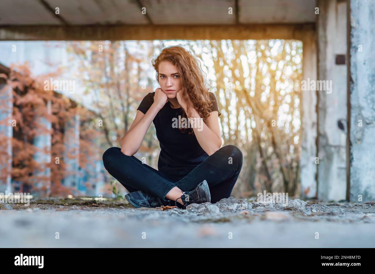 Sad girl sitting cross legged hi-res stock photography and images - Alamy