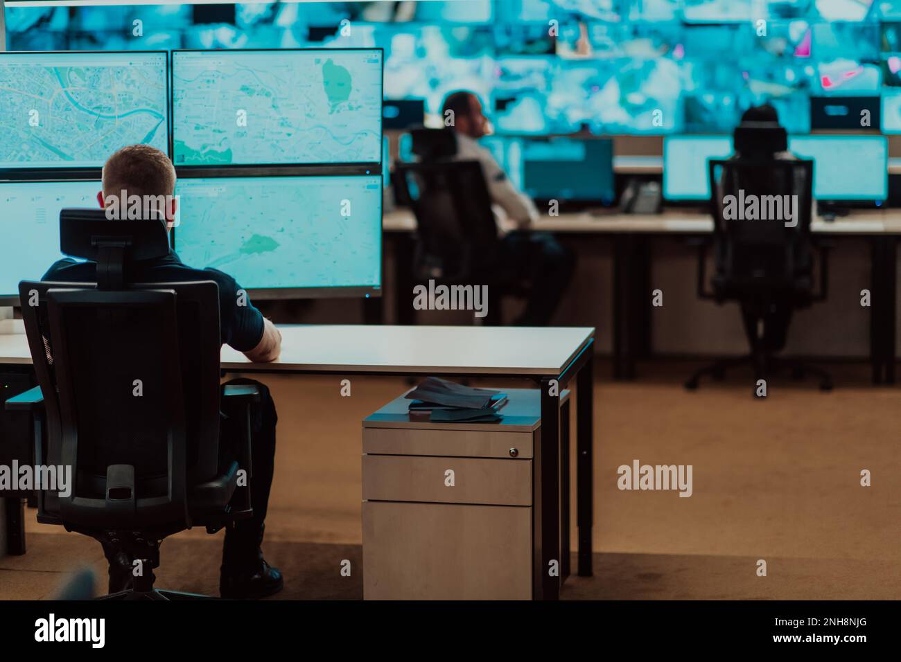 Group of Security data center operators working in a CCTV monitoring ...
