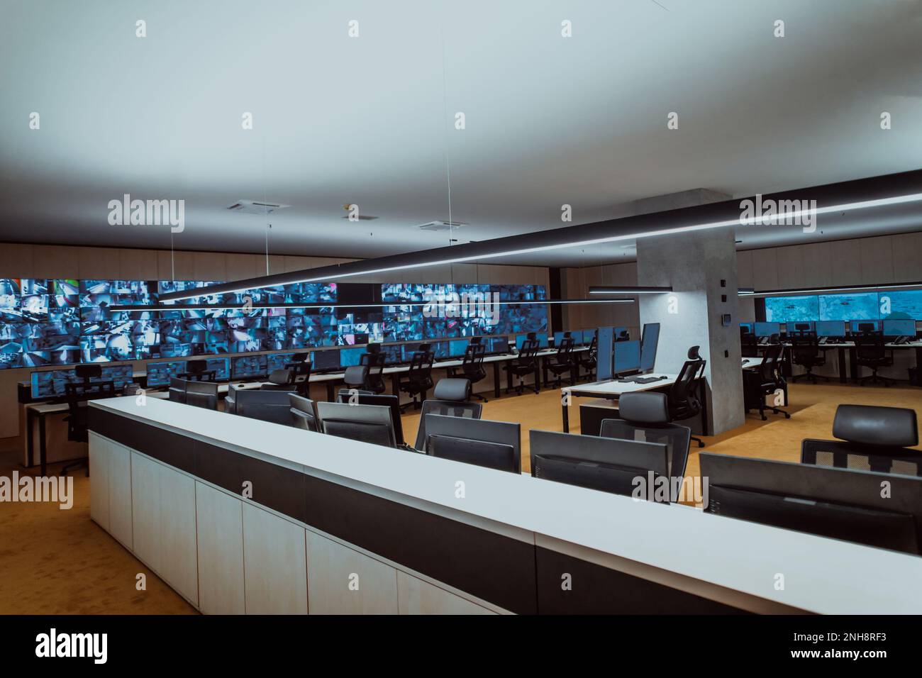 Empty interior of big modern security system control room, workstation ...