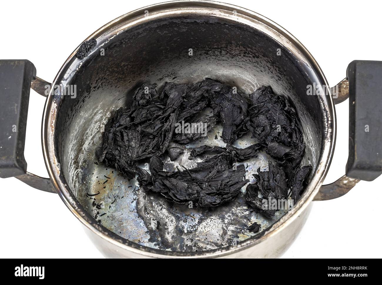 A stainless steel pot with burnt food from being left on the stove on ...
