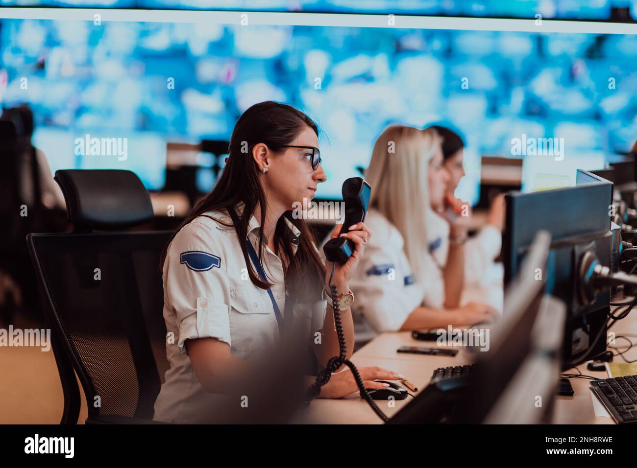 Group of Security data center operators working in a CCTV monitoring ...