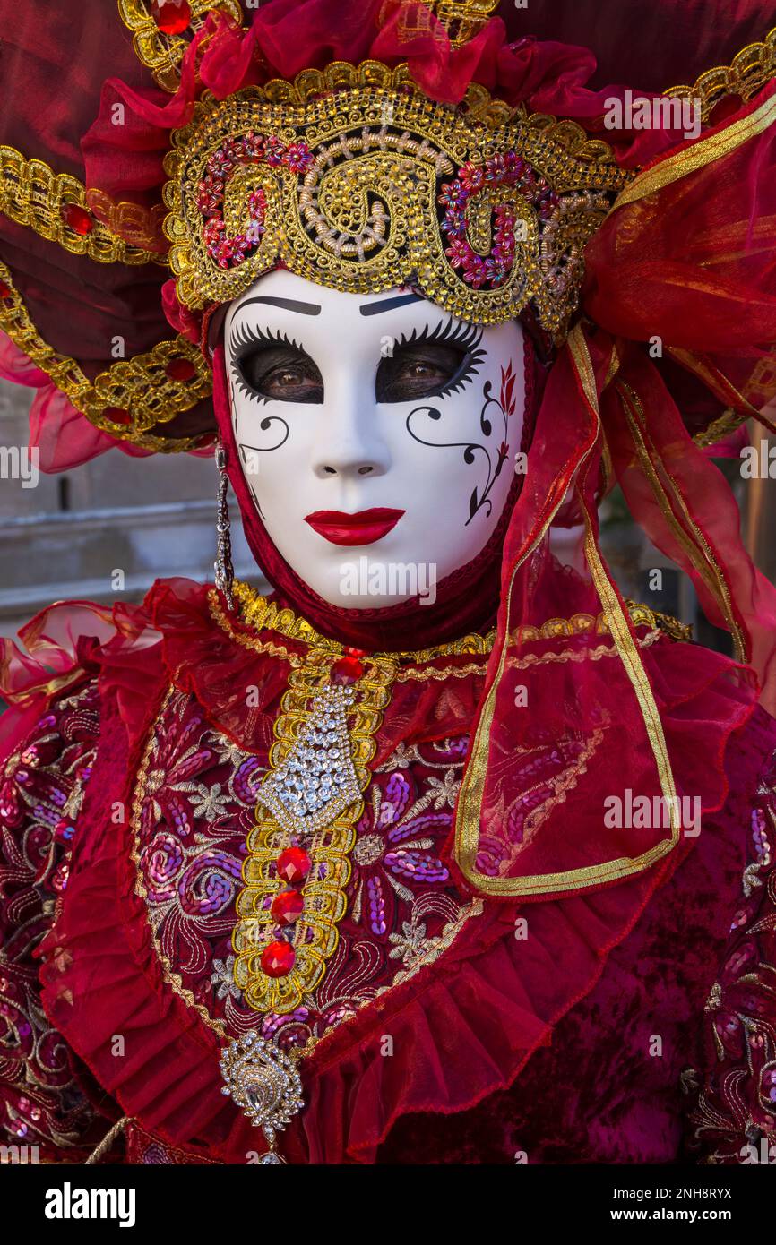 Carnival Goer Dressed In Splendid Red And Gold Coloured Costume And