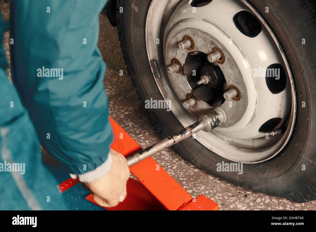 Man changes wheel of car in car service. Professional auto mechanic in ...