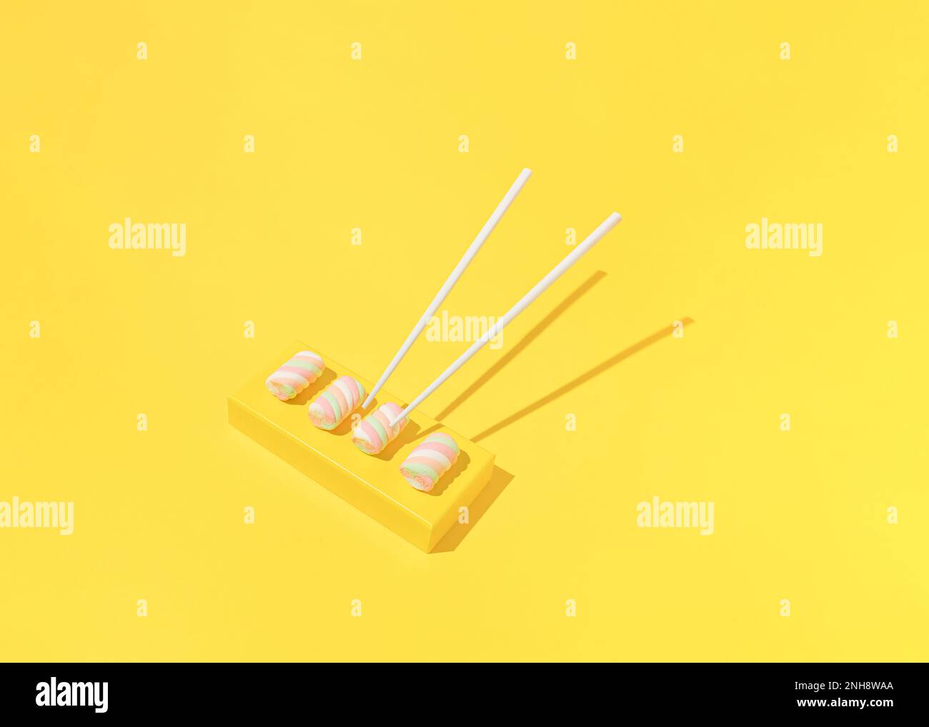 Colorful marshmallow candies served as sushi on yellow background. Top ...