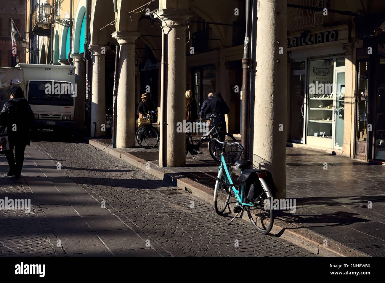 Bike parked next to a column of a porch in an italian town Stock Photo ...