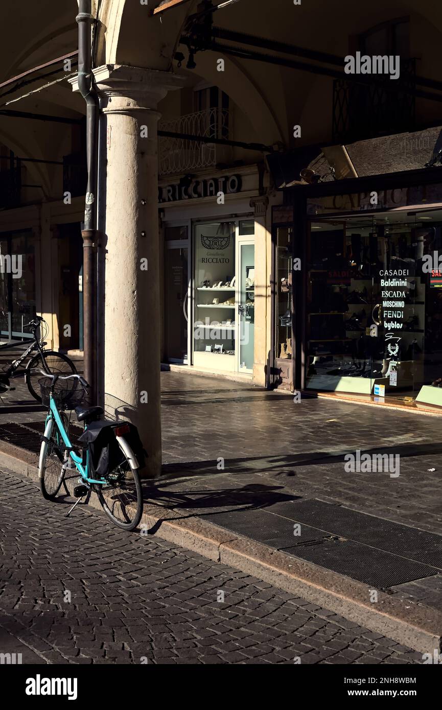 Bike parked next to a column of a porch in an italian town Stock Photo ...